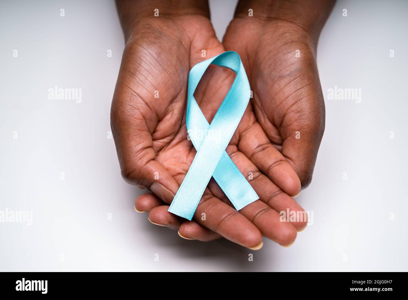 Human Hand Showing Teal Ribbon To Support Cervical Awareness Stock ...