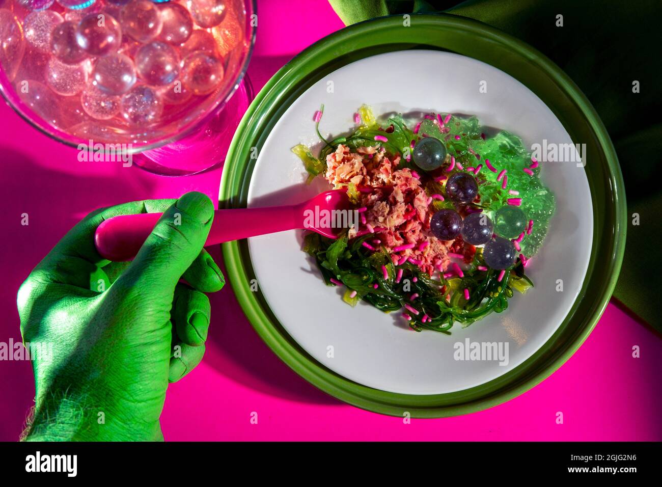 Science fiction green alien from outer space eating dinner at a fancy ...