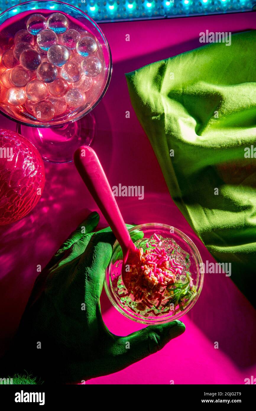 Science fiction green alien from outer space eating dinner at a fancy ...