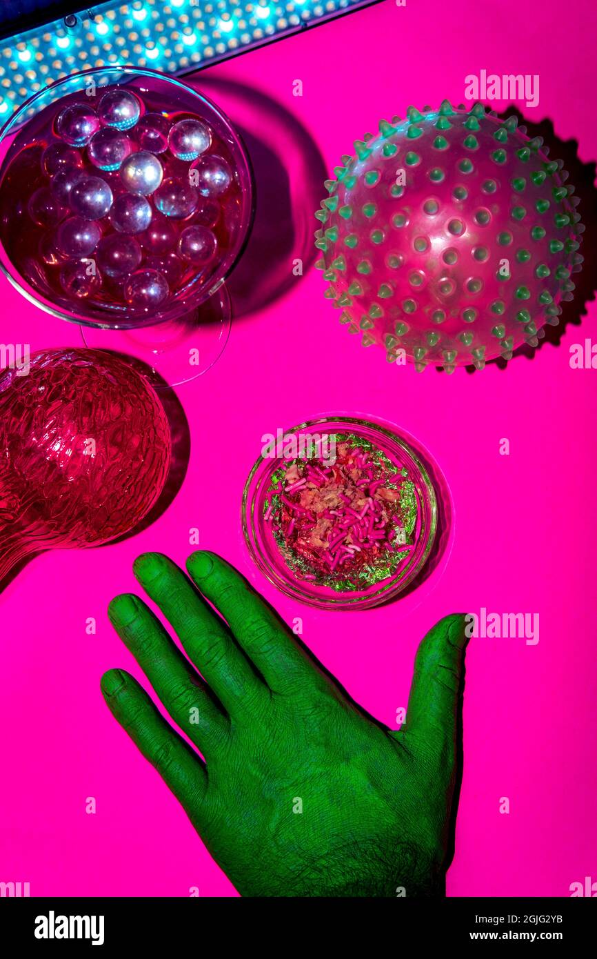 Science fiction green alien from outer space eating dinner at a fancy ...