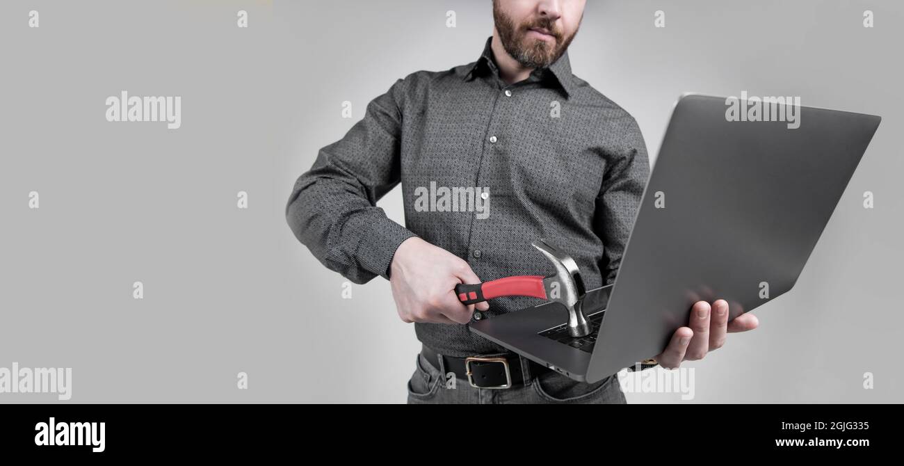Unshaven man cropped view break laptop hitting computer with hammer ...