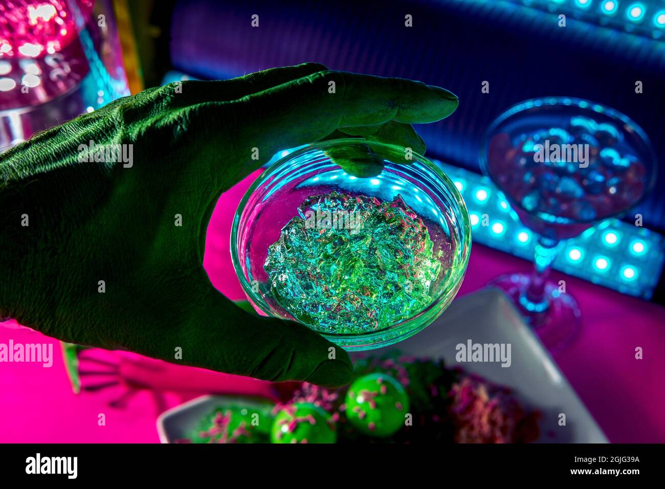 Science fiction green alien from outer space eating dinner at a fancy ...