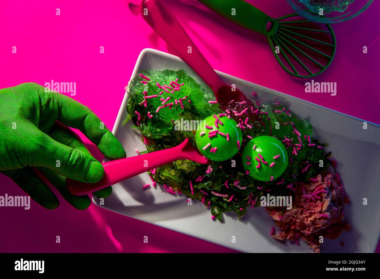 Science fiction green alien from outer space eating dinner at a fancy ...