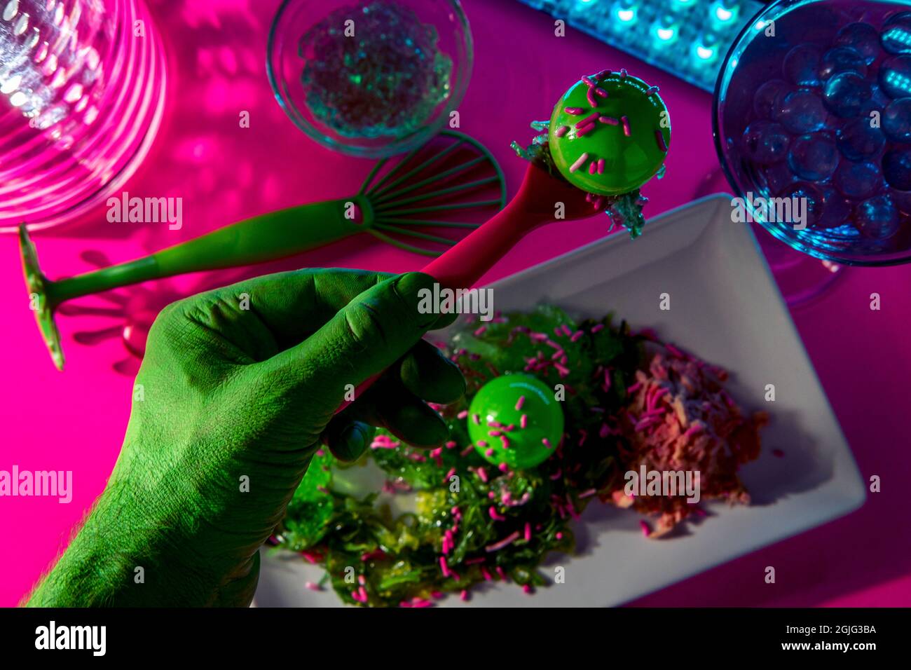 Science fiction green alien from outer space eating dinner at a fancy ...
