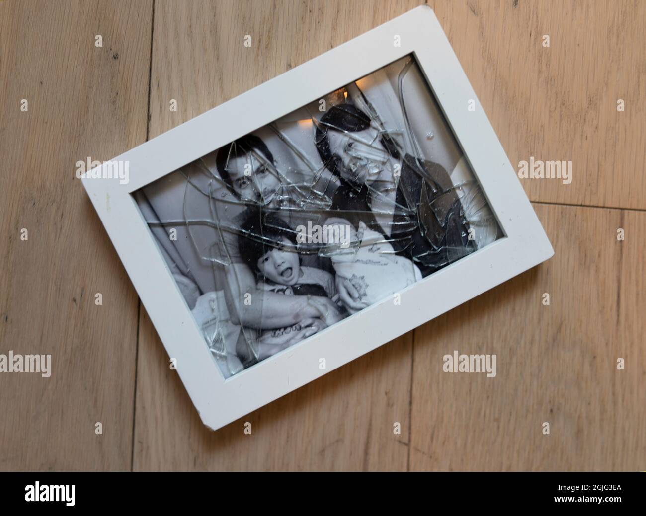 family of four in broken frame Stock Photo - Alamy