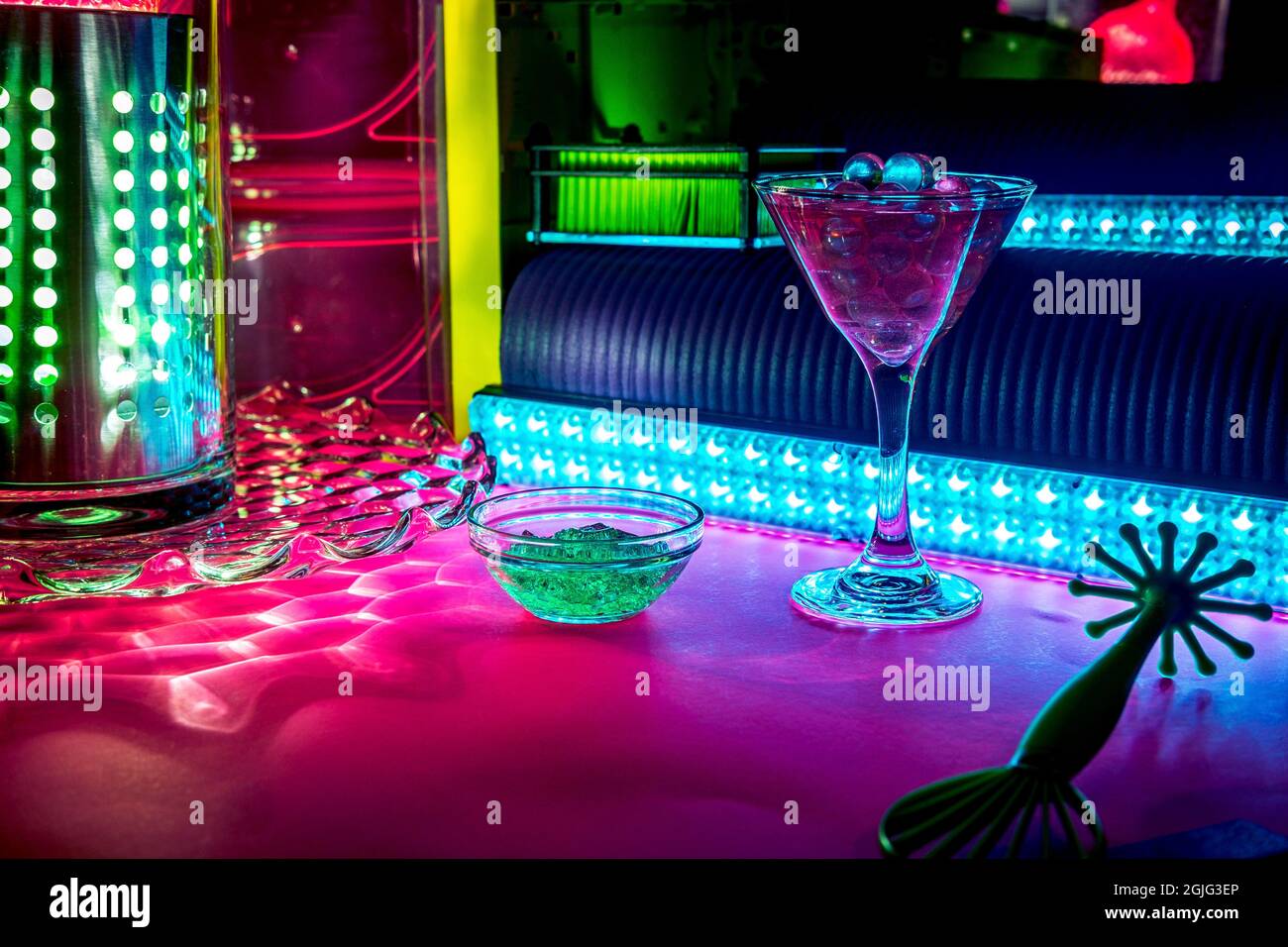 Science fiction alien from outer space having a martini at a fancy ...