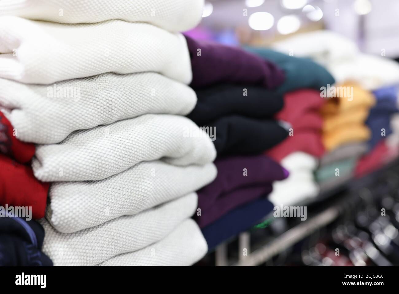 Folded clothes lying on store shelf closeup Stock Photo - Alamy