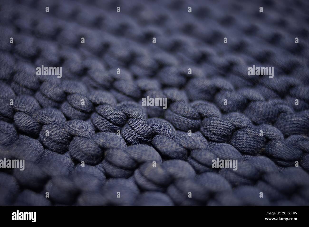 Dark pale blue background large knitted thread pattern Stock Photo - Alamy