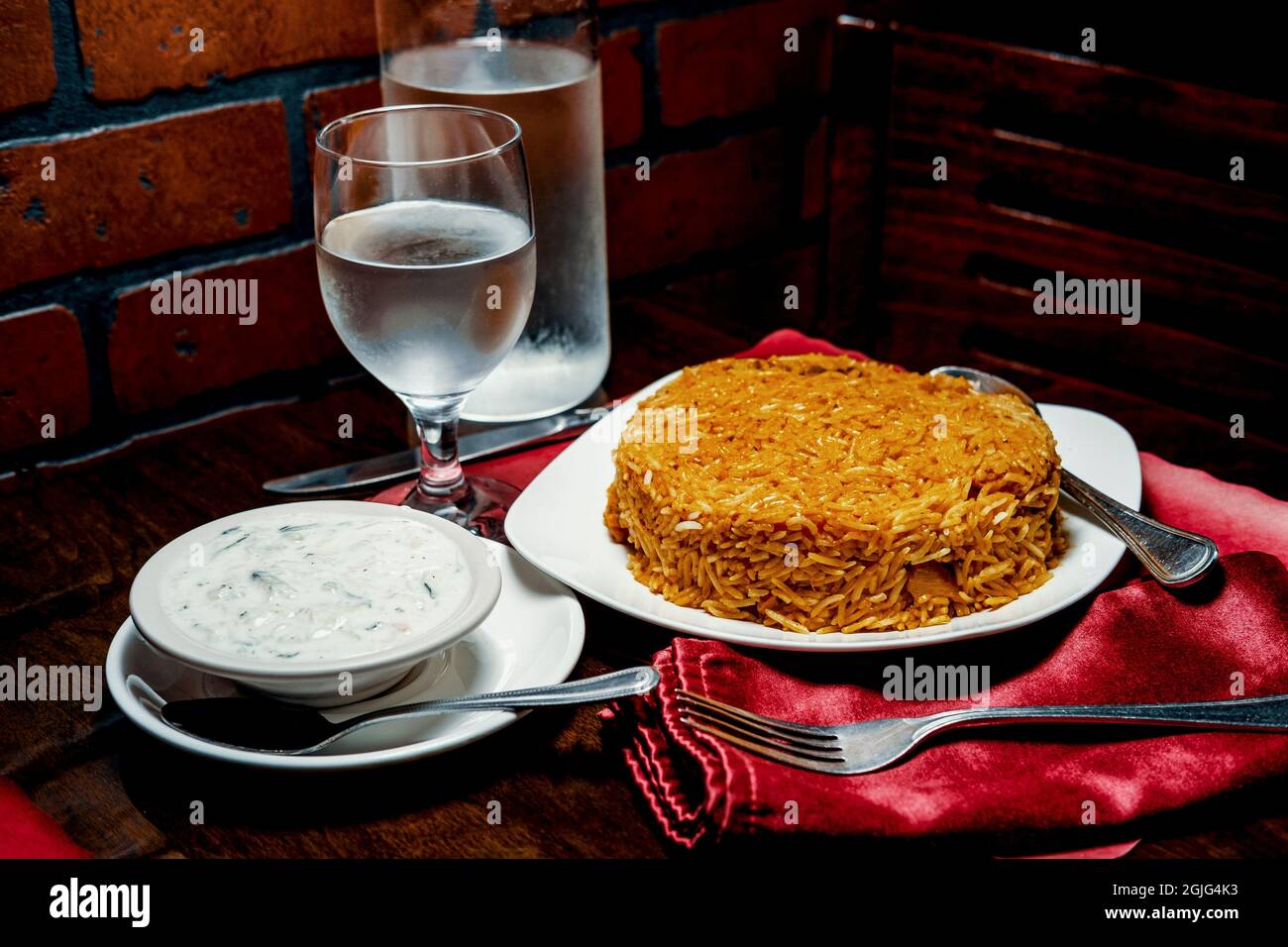 Spicy Indian chicken biryani rice with fresh raita Stock Photo - Alamy