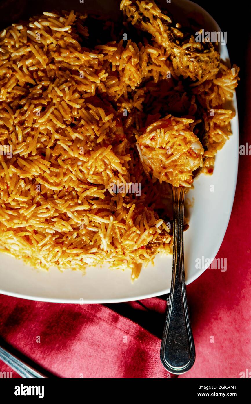 Spicy Indian chicken biryani rice with fresh raita Stock Photo - Alamy