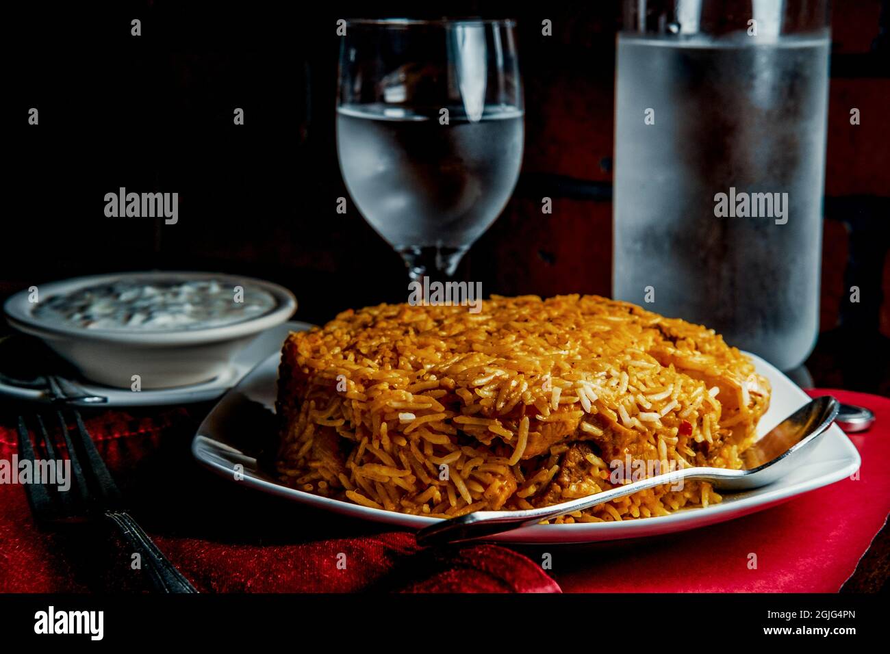 Spicy Indian chicken biryani rice with fresh raita Stock Photo - Alamy