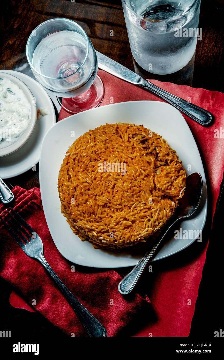 Spicy Indian chicken biryani rice with fresh raita Stock Photo - Alamy