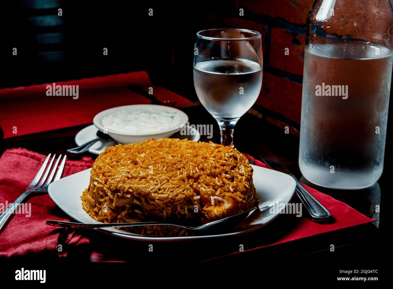 Spicy Indian chicken biryani rice with fresh raita Stock Photo - Alamy