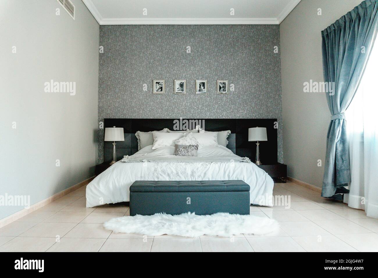 Stylish bedroom interior with bed and lamps in Doha Qatar Stock Photo ...