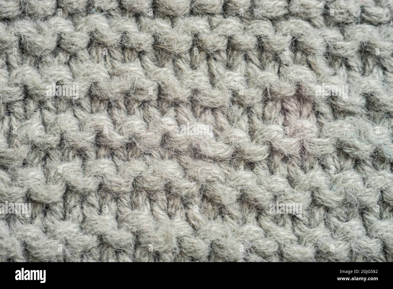 Pale grey background of knitted thread pattern Stock Photo - Alamy