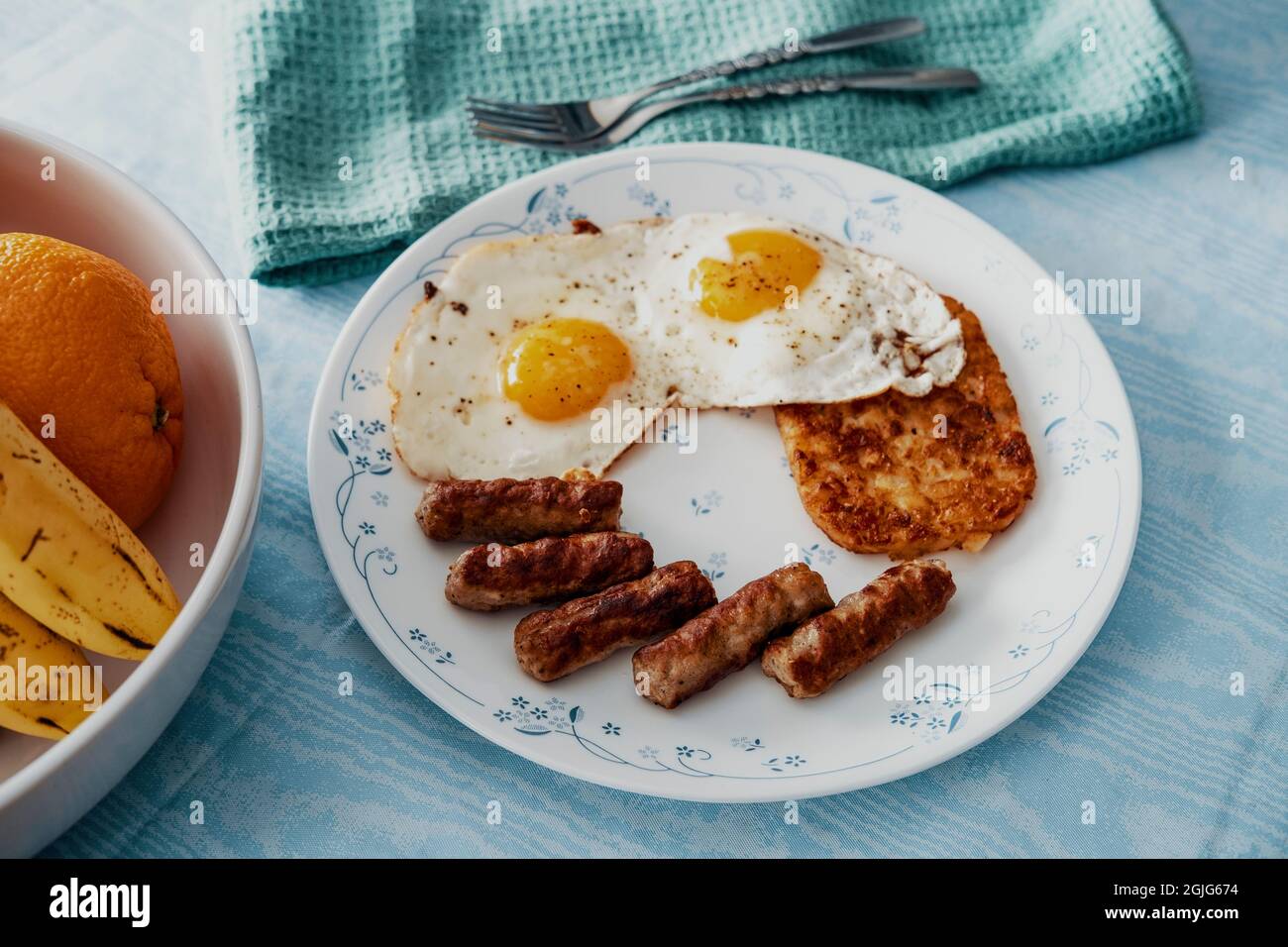 Complete American breakfast two fried sunny side up eggs sausage and ...