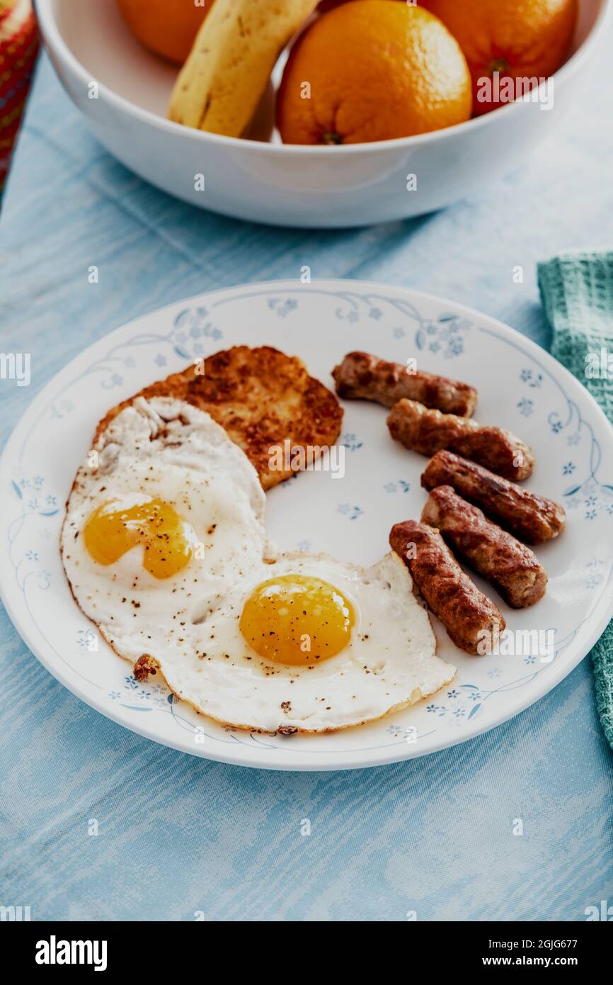 Complete American breakfast two fried sunny side up eggs sausage and ...
