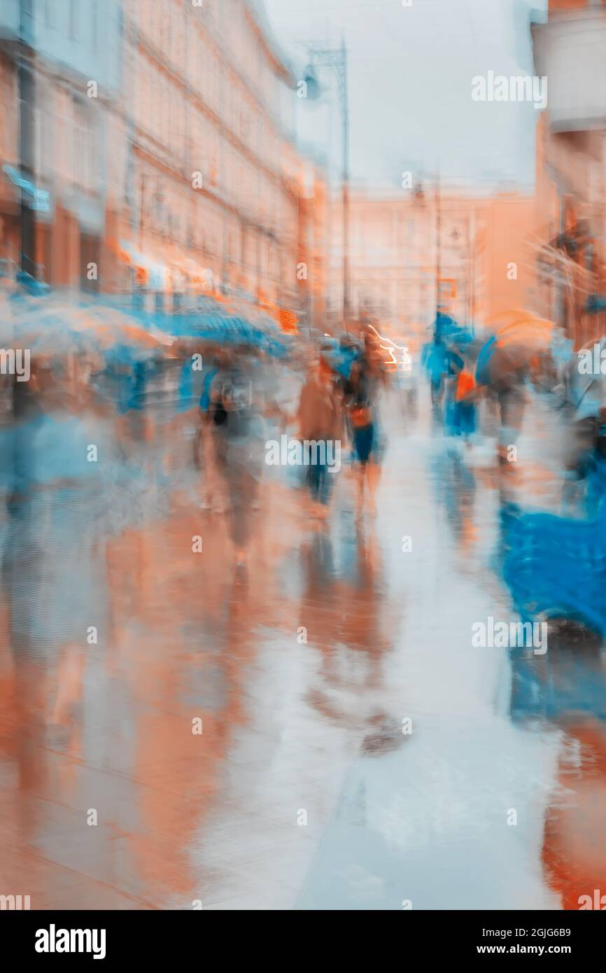 Rainy evening. City street, people crowd, abstract colorful background ...