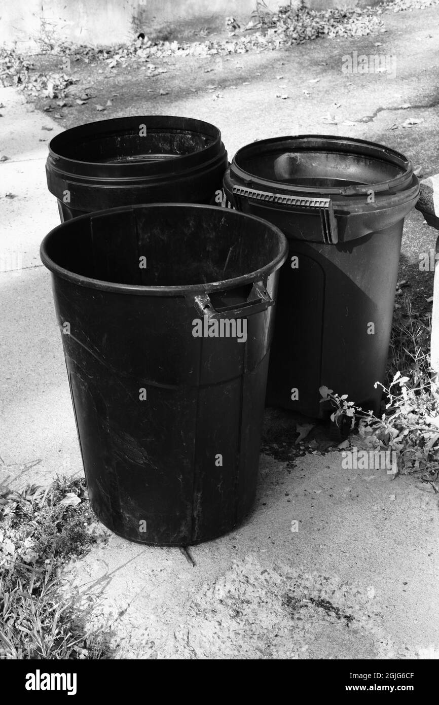 Several empty garbage cans at the end of the driveway Stock Photo - Alamy