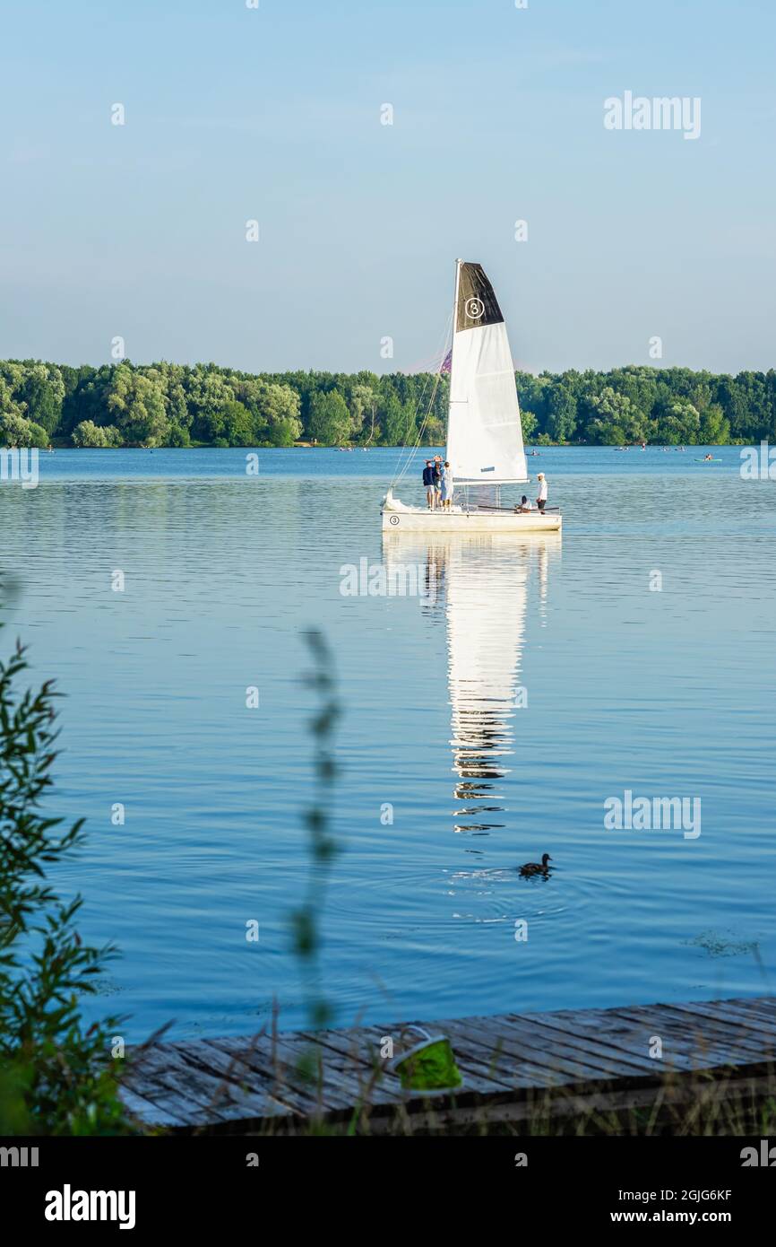 White sailing yacht with white sails floating on blue water, summer ...
