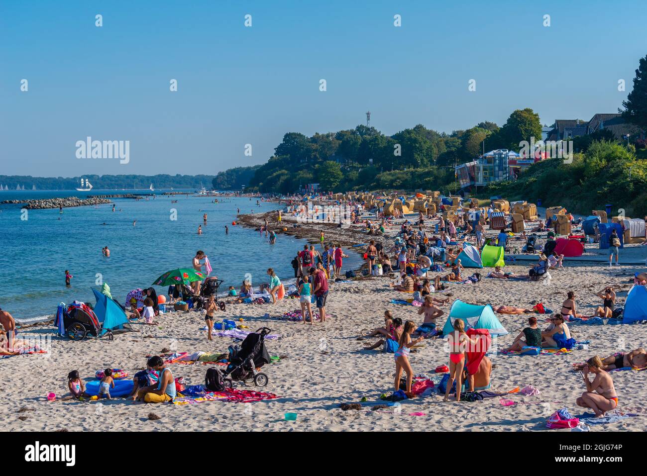 Sandy beach in Kiel-Schilksee on the Baltic Sea, people sunbathing and ...