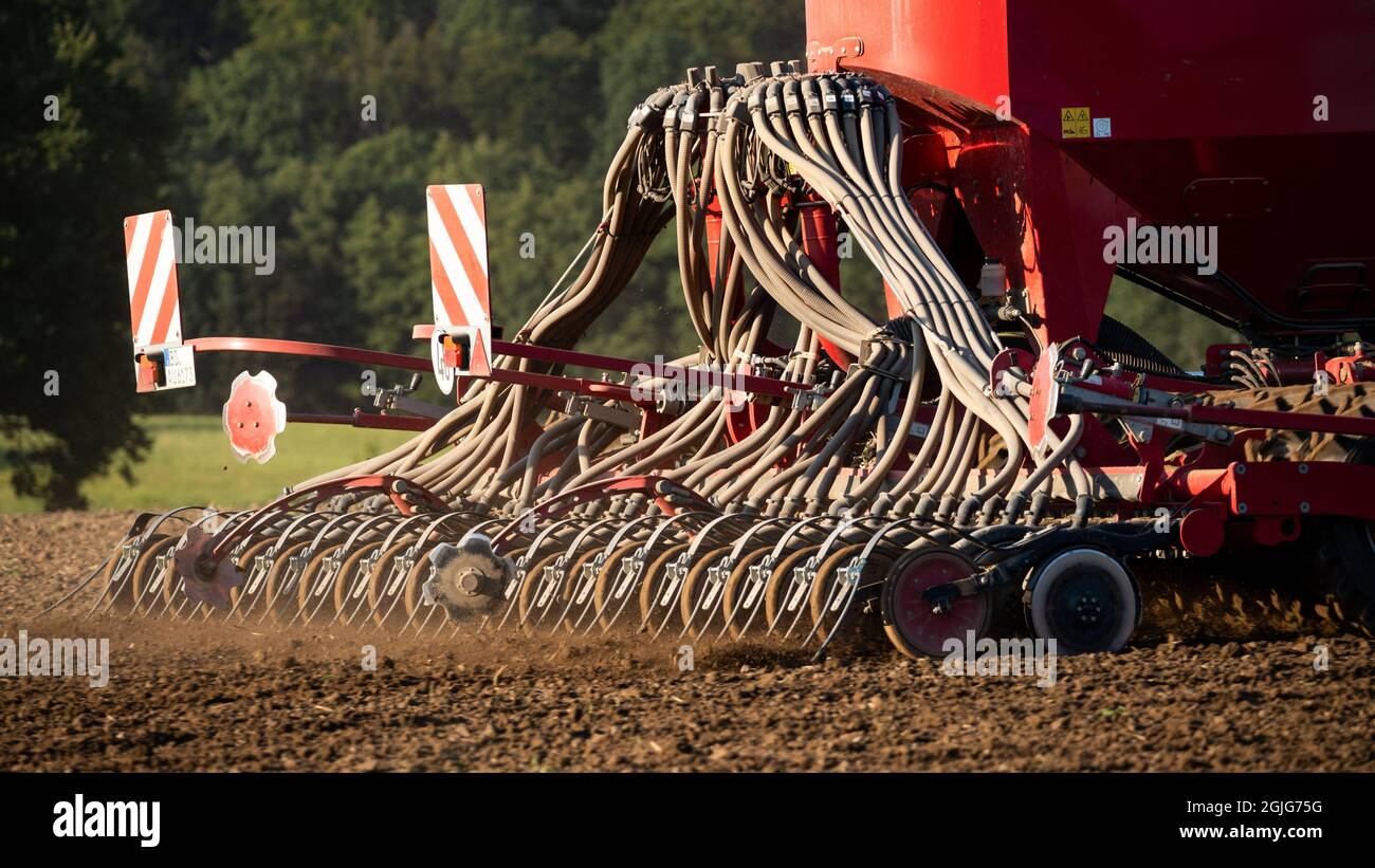 modern plough ploughing a dirt field Stock Photo - Alamy