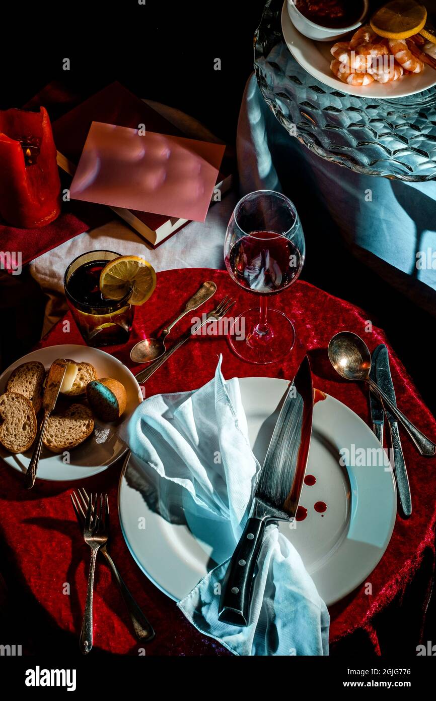 Macabre murder mystery dinner party event with bloody knife Stock Photo ...