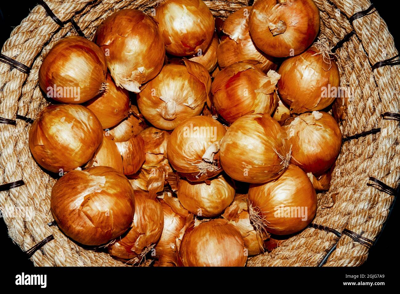 Organic yellow onions in wicker basket on display at local farmers ...