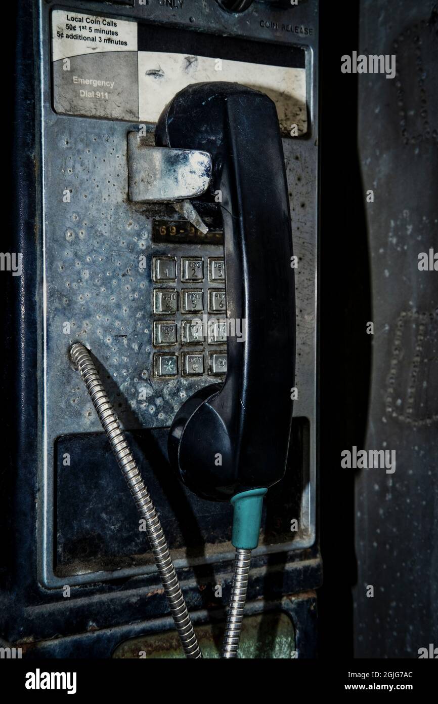 Old dirty vintage payphone on city street covered in car exhaust and ...