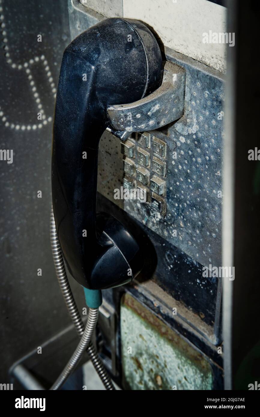 Old dirty vintage payphone on city street covered in car exhaust and ...