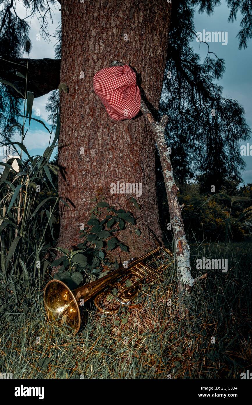 Traveling musicians trumpet and handkerchief picnic sack on a stick ...