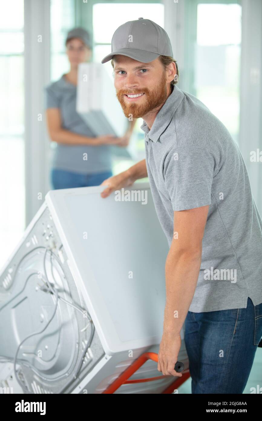 Man carrying washing machine hi-res stock photography and images - Alamy