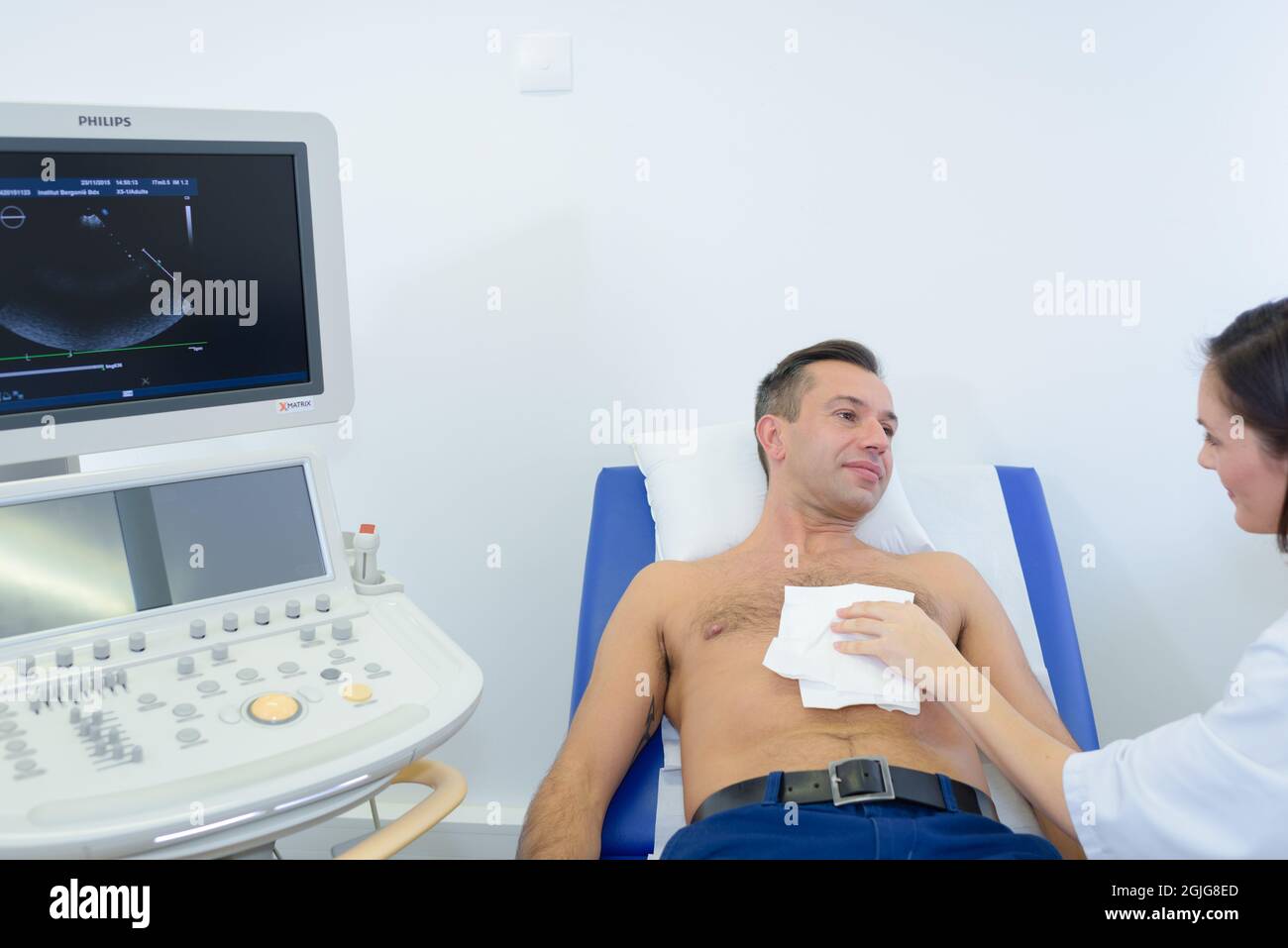 a nurse wiping the patients chest Stock Photo - Alamy