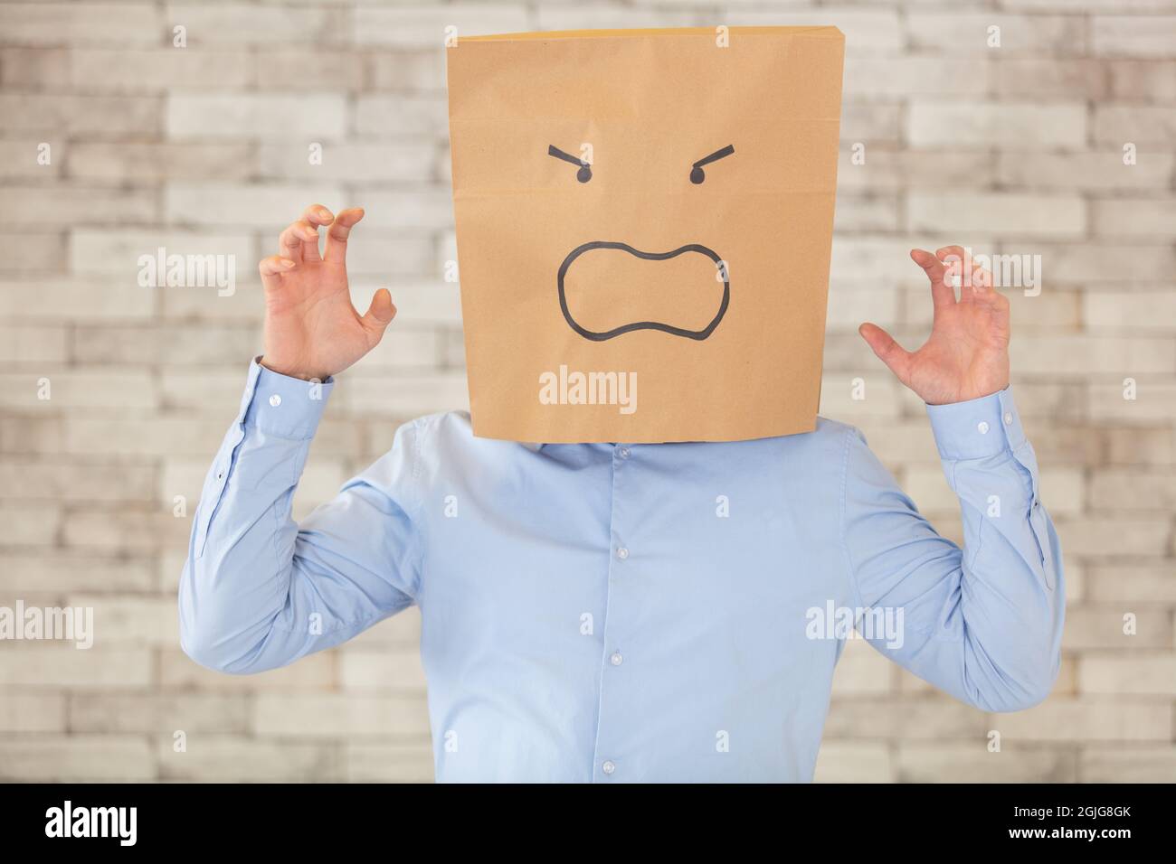 angry businessman wearing paper bag with drawing of angry face Stock ...