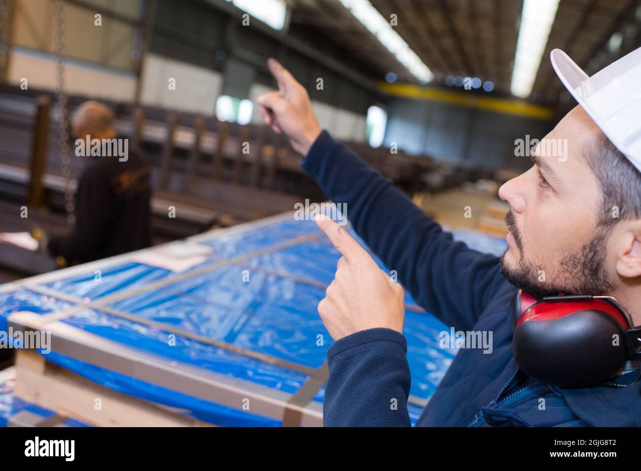 serviceman pointing at a machine room Stock Photo - Alamy