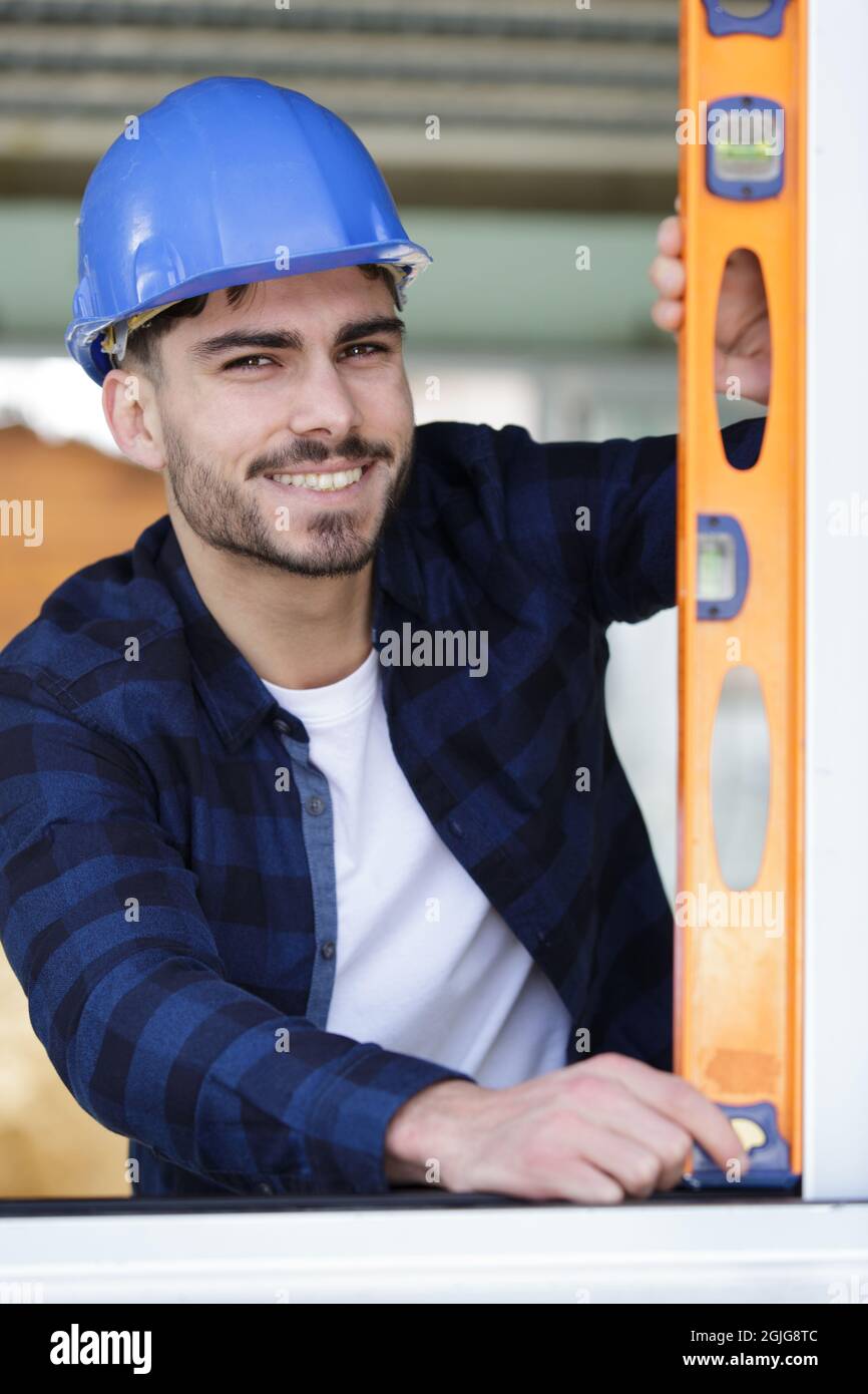 contractor checking window installation with a spirit level Stock Photo ...