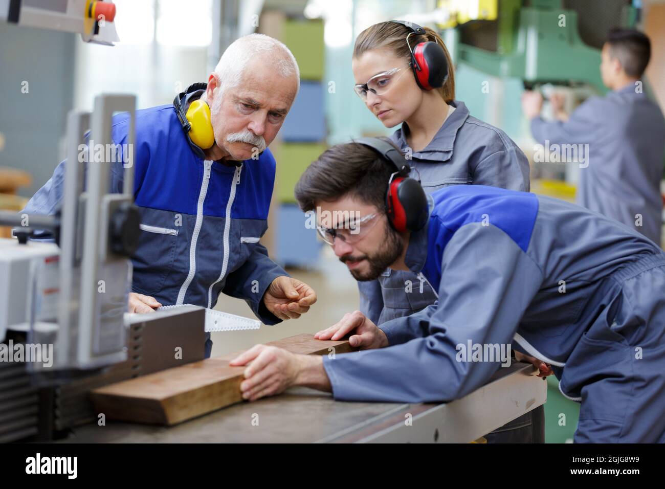 teacher showing students machine with extractor hose Stock Photo - Alamy