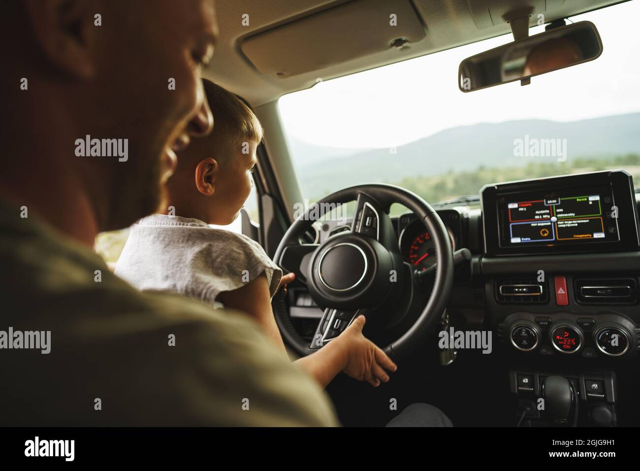 Father teaches little son to drive on road trip Stock Photo - Alamy