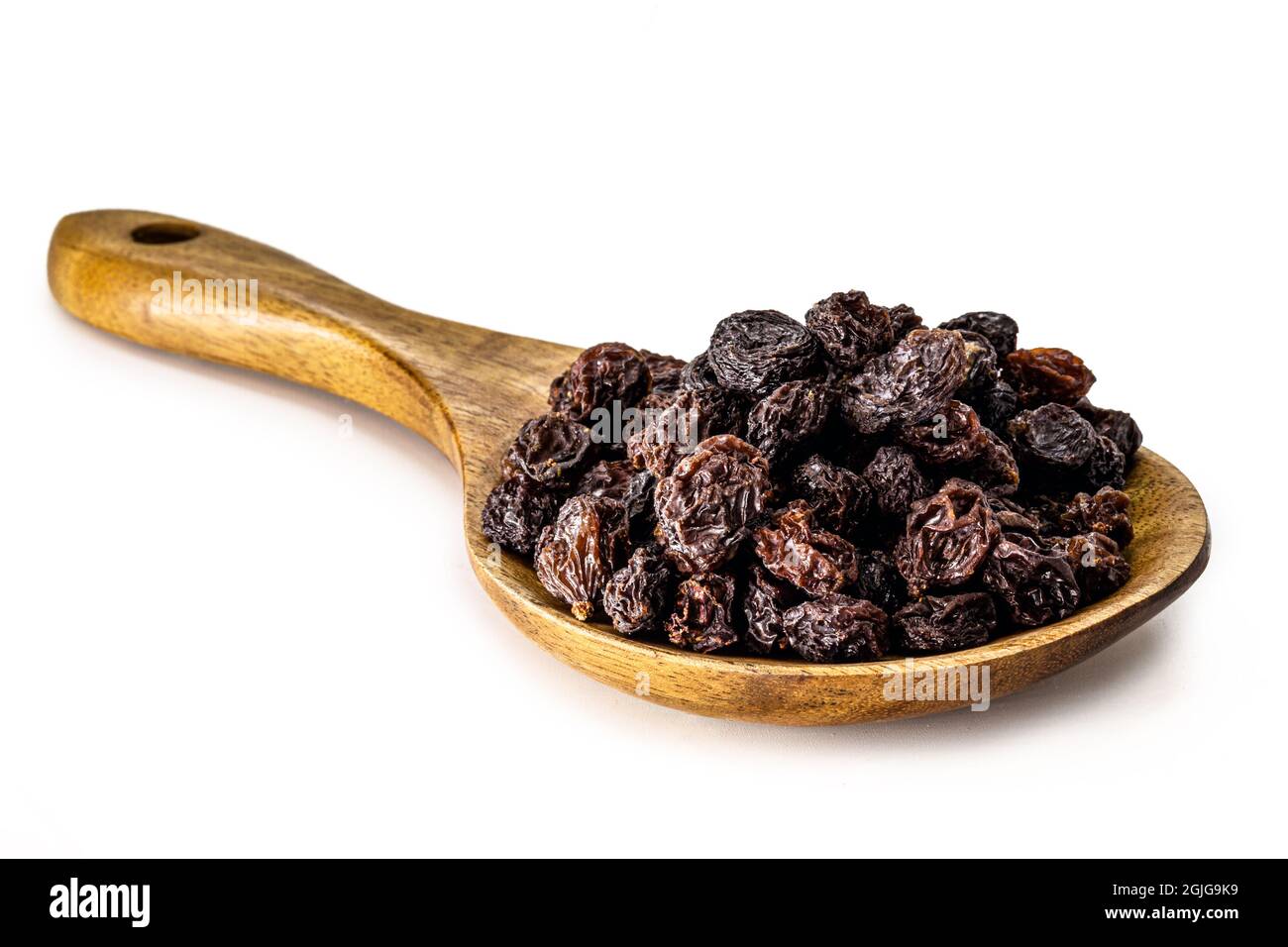 dried dried raisin made in brazil in rustic wooden spoon, isolated ...