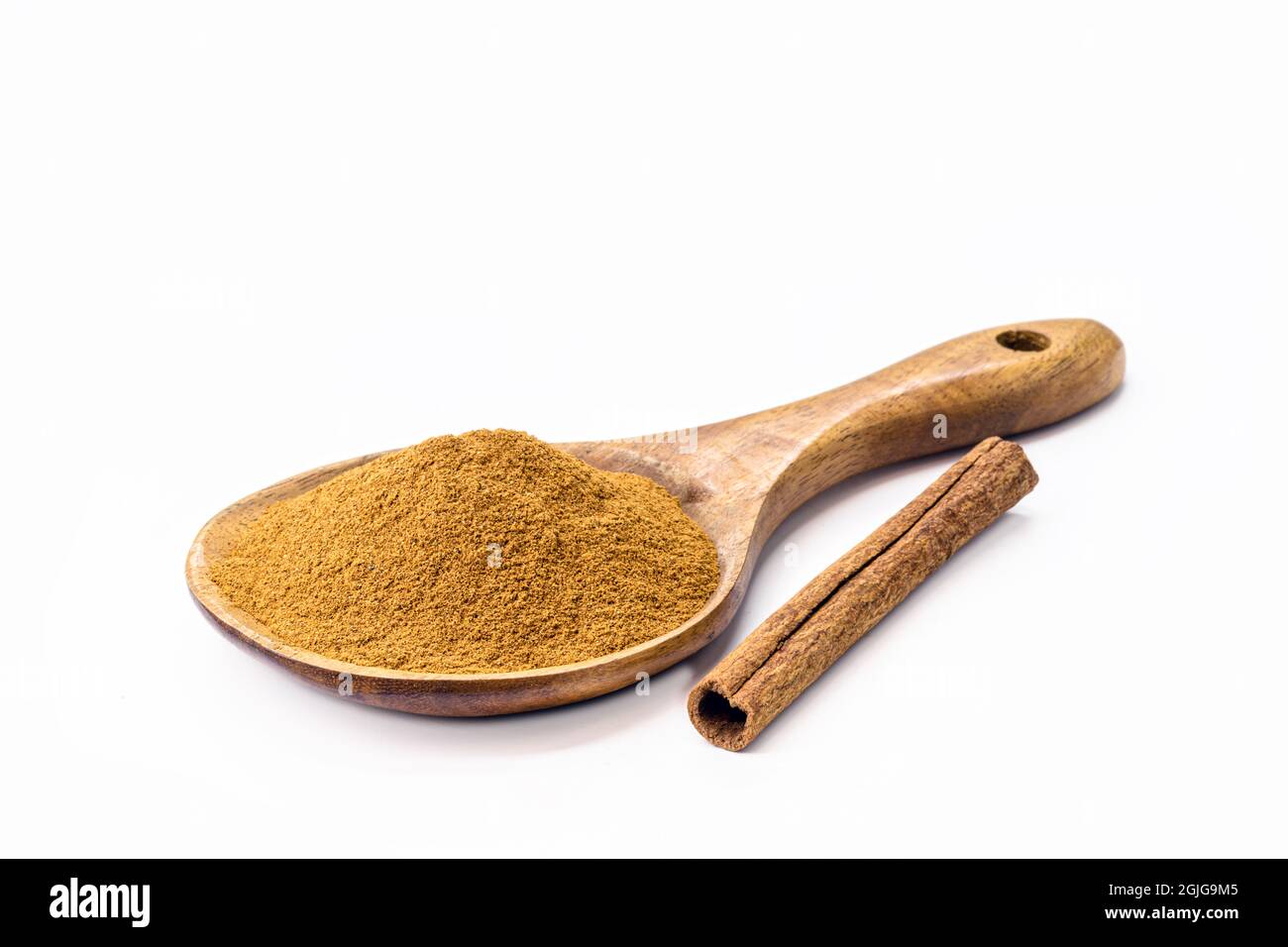 cinnamon powder with cinnamon stick in rustic wooden spoon, isolated ...