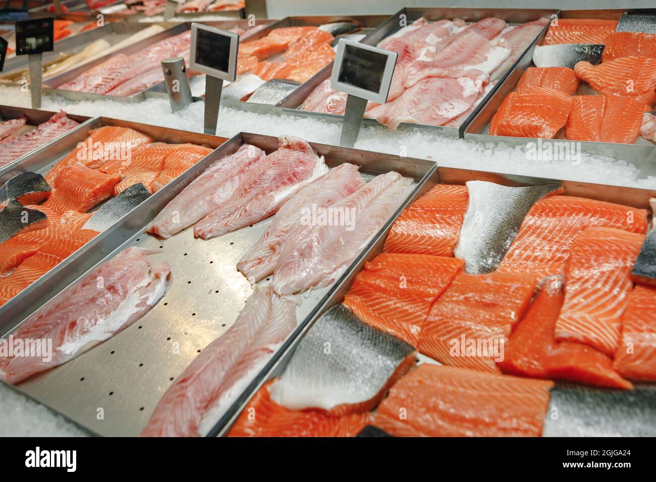 Fresh fish assorted on ice counter in supermarket Stock Photo - Alamy