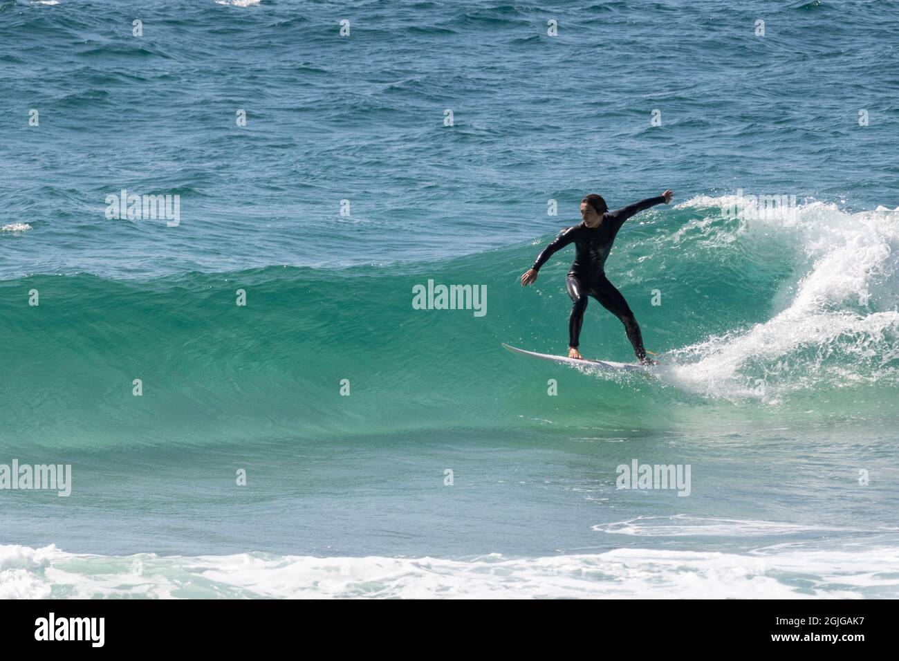 Professional surfboarding on a large wave in the sea Stock Photo - Alamy