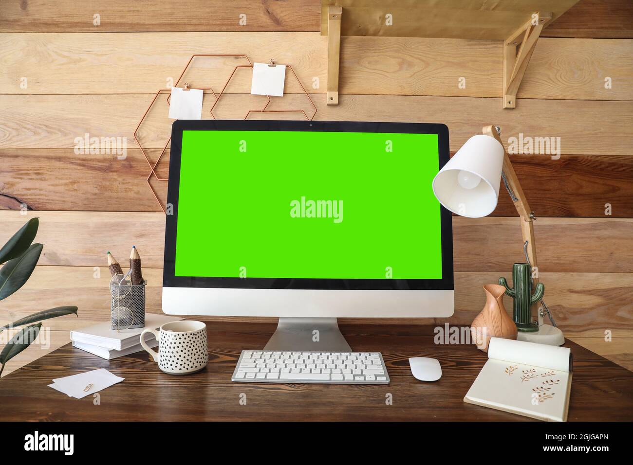 Modern monitor with blank screen at workplace in room Stock Photo - Alamy