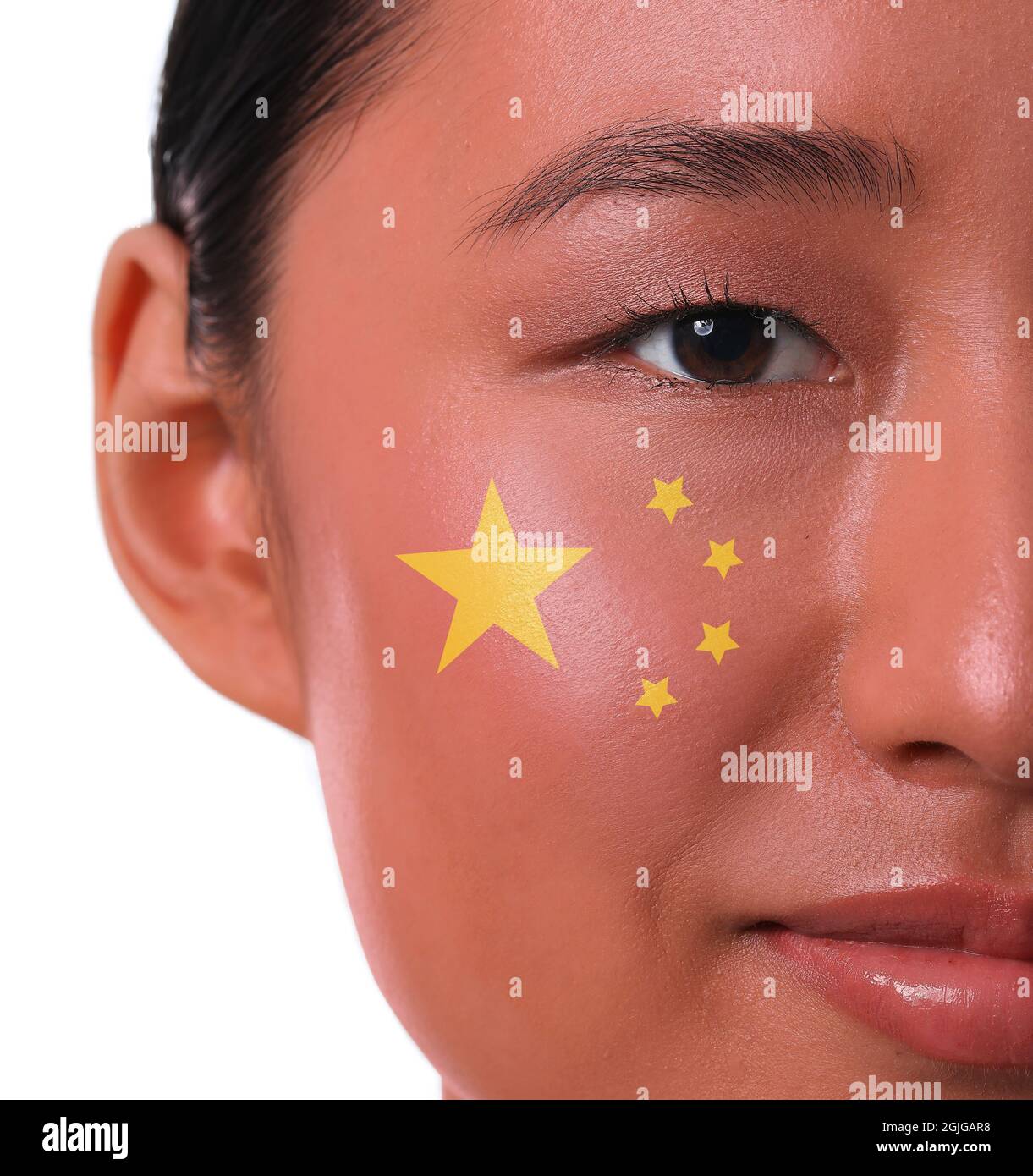 Young woman with face in colors of Chinese flag on white background ...