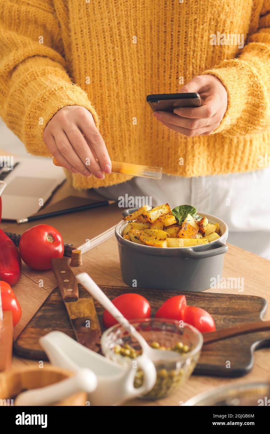 Female food photographer with mobile phone taking picture of tasty ...