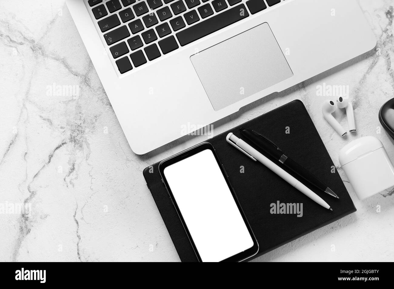 Different modern devices and notebook on light background Stock Photo ...