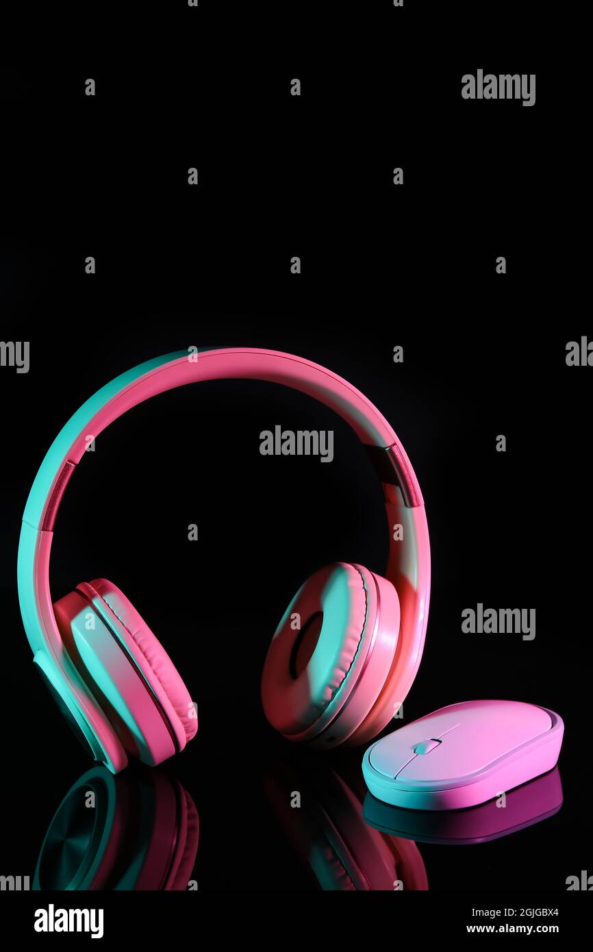 Modern computer mouse and headphones on dark background Stock Photo - Alamy