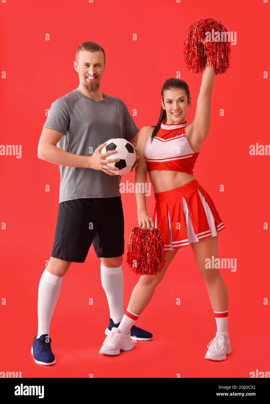 Cheerleader and football player on color background Stock Photo - Alamy