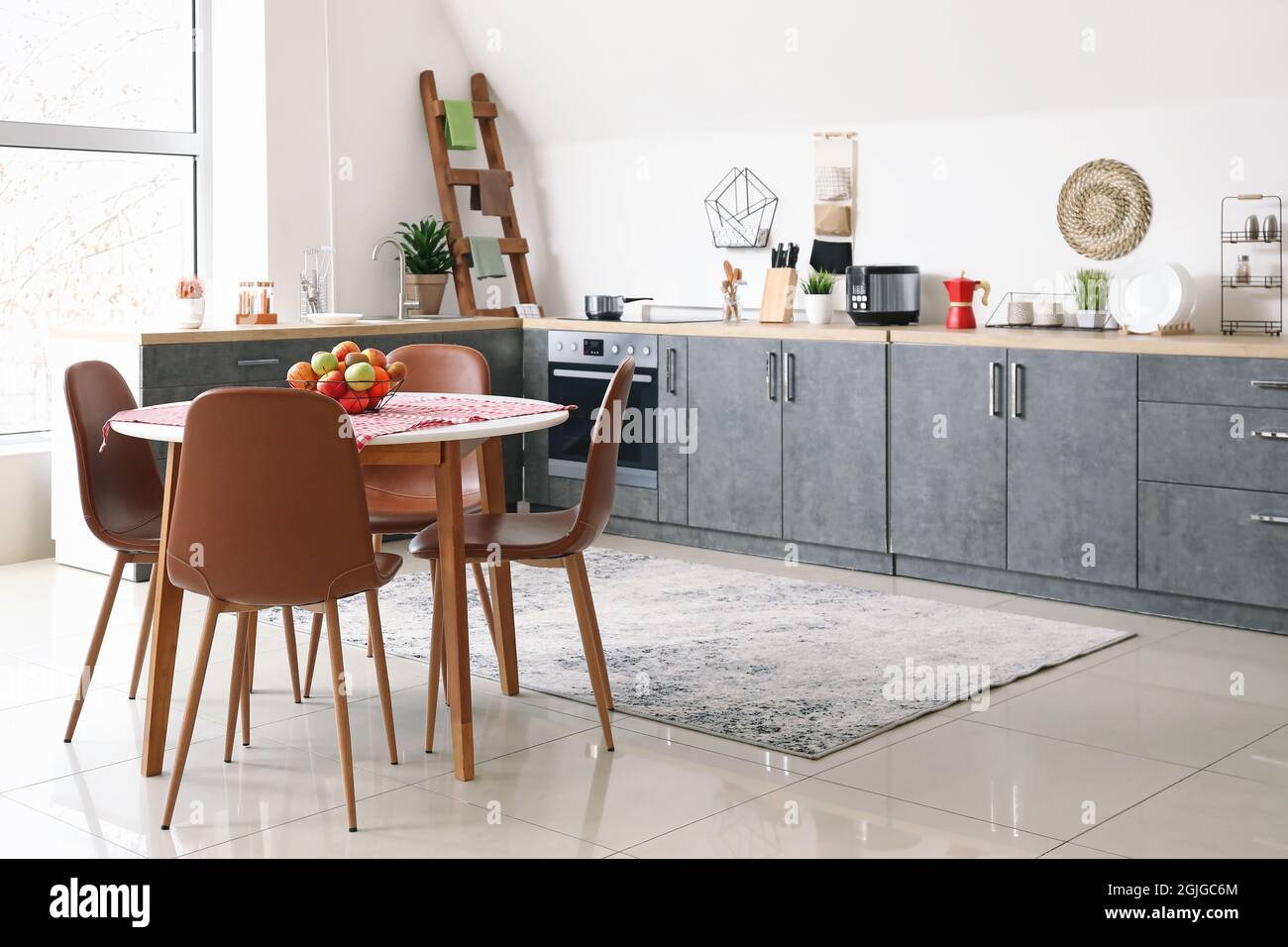 Stylish interior of modern kitchen with dining table Stock Photo - Alamy