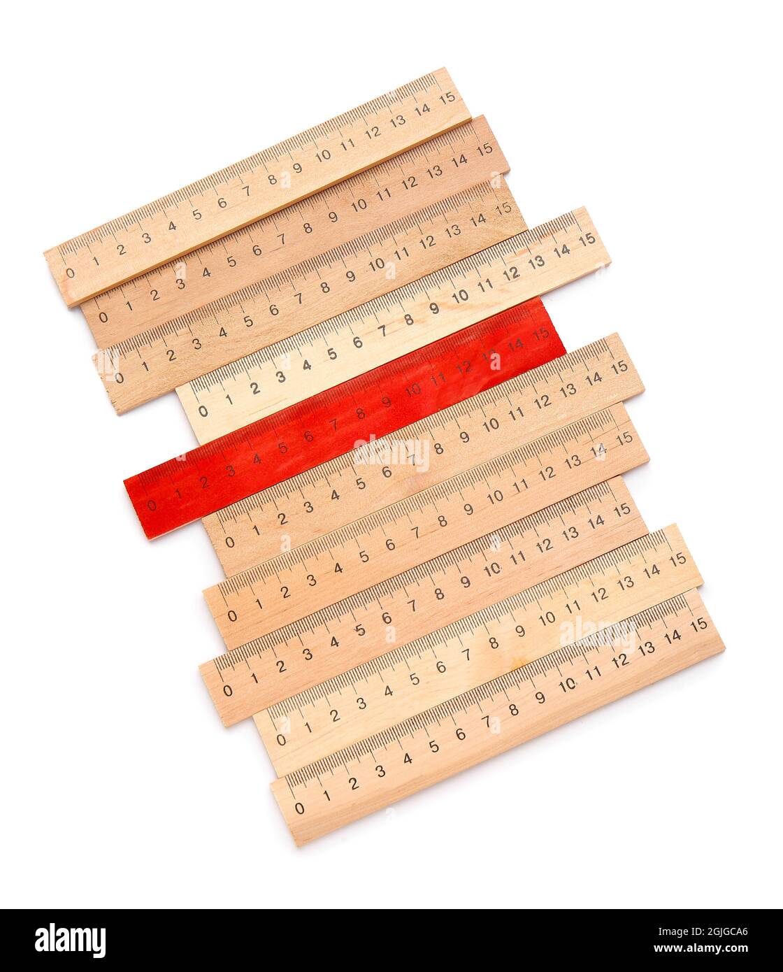 Red ruler among wooden ones on white background. Concept of uniqueness ...
